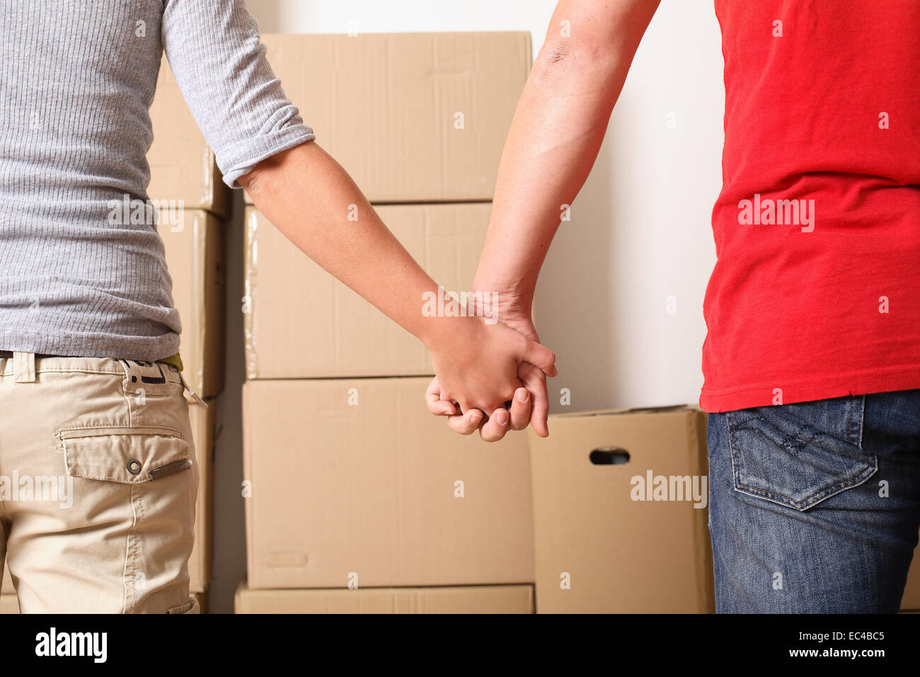 Young Couple Moving Home, Holding Hands Stock Photo - Alamy