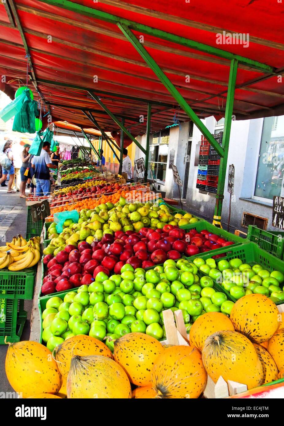 Fruit stand with melons, apples, bananas Stock Photo - Alamy