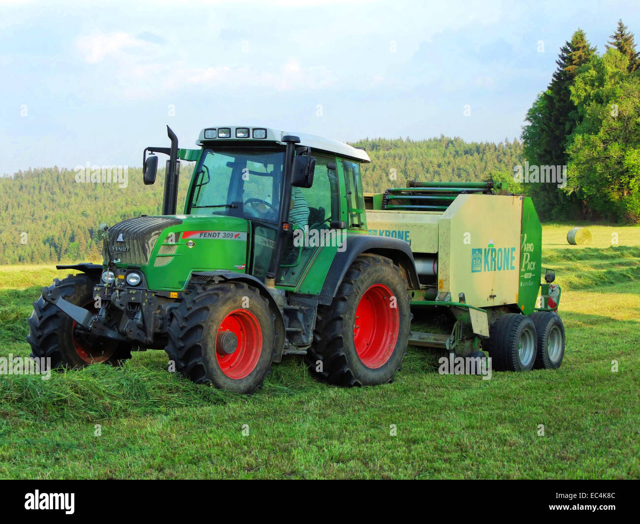 Hay riding a tractor with ARIO Pack Stock Photo - Alamy