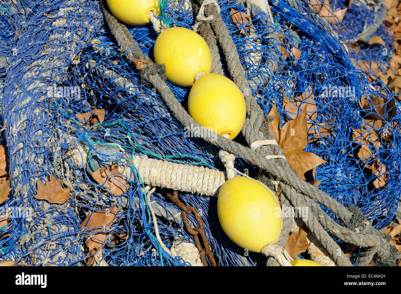 Fishing net with yellow floats laid out to dry Stock Photo - Alamy