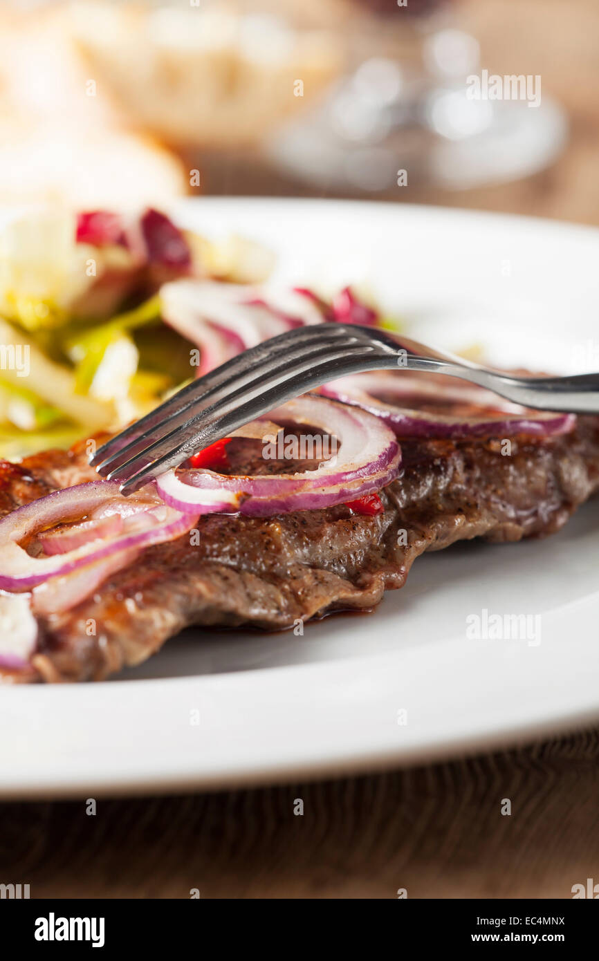 Fork on a steak Stock Photo - Alamy