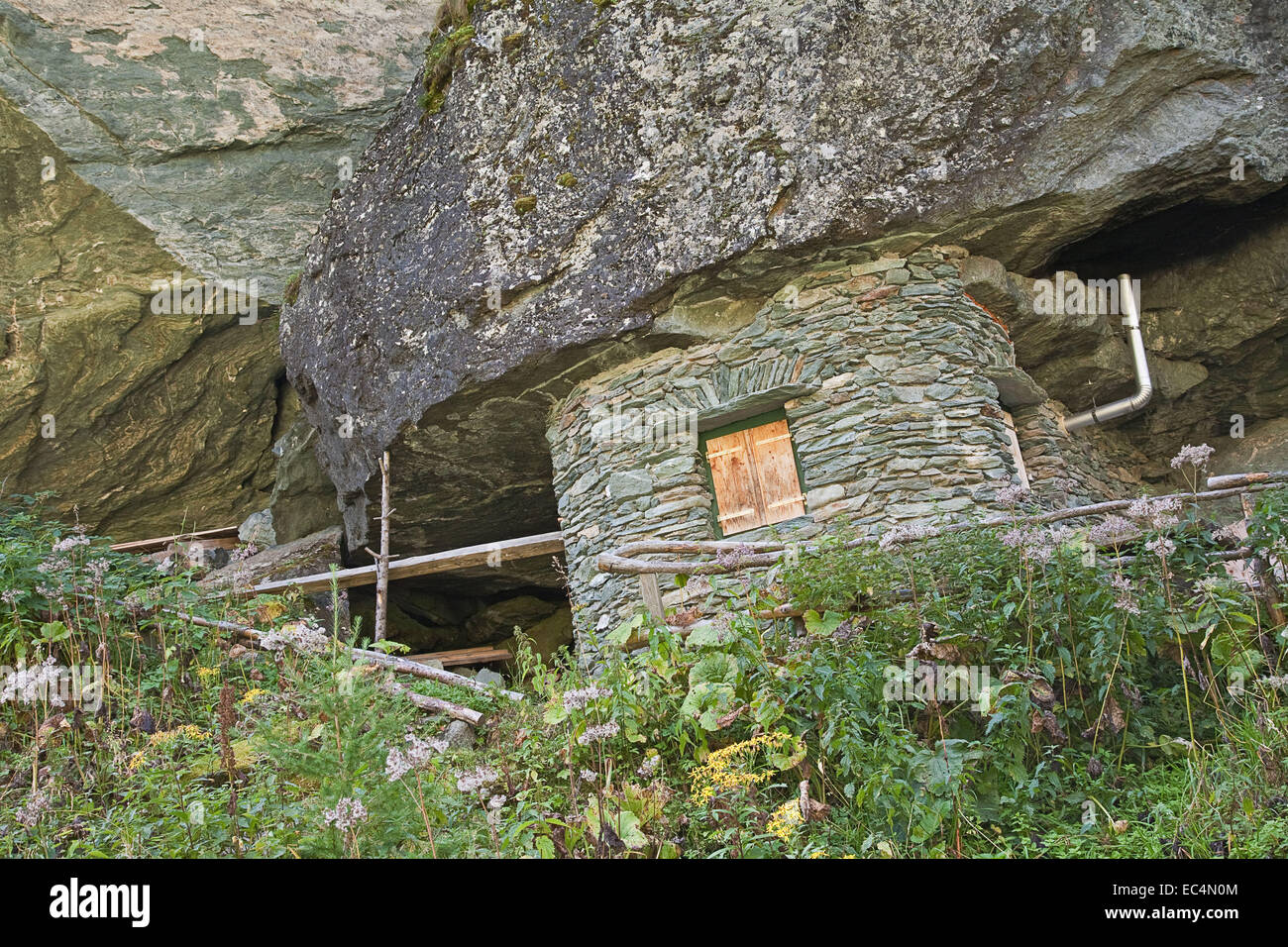 Hut built in a crevice Stock Photo - Alamy