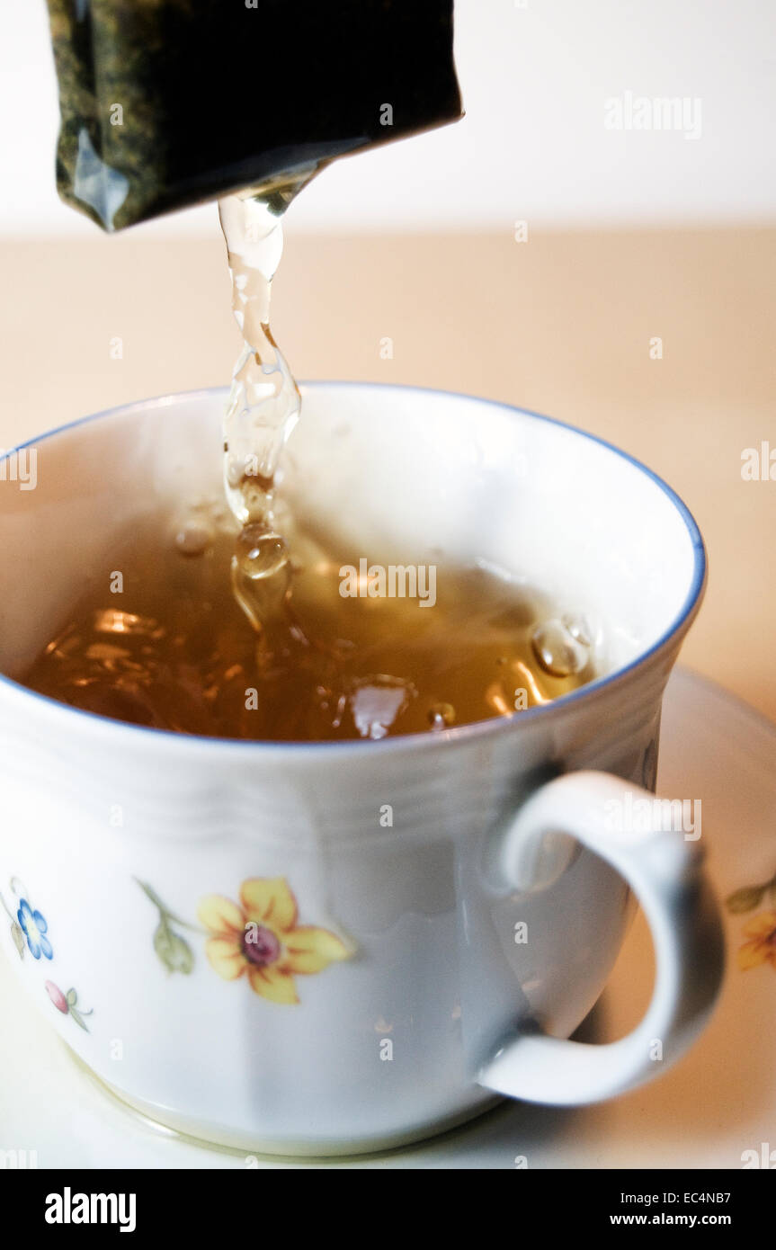 teabag pulled out a cup Stock Photo - Alamy