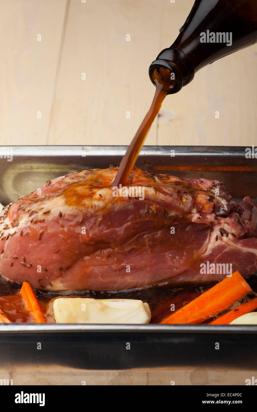 pouring beer over the pork Stock Photo - Alamy