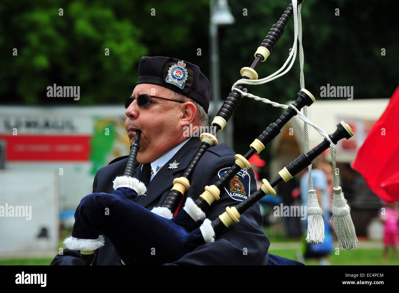 A police bagpiper plays during Canada Day Celebrations held in London ...