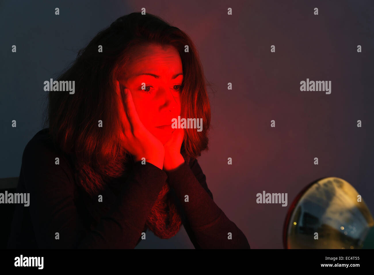 young woman in the light of a red light Stock Photo - Alamy