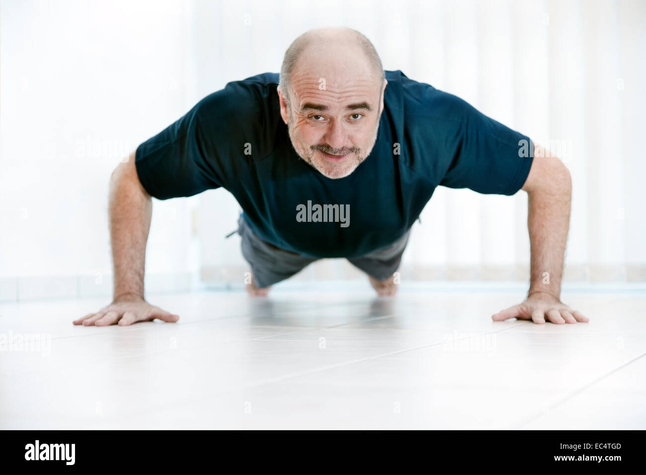 Senior sports makes push ups Stock Photo - Alamy