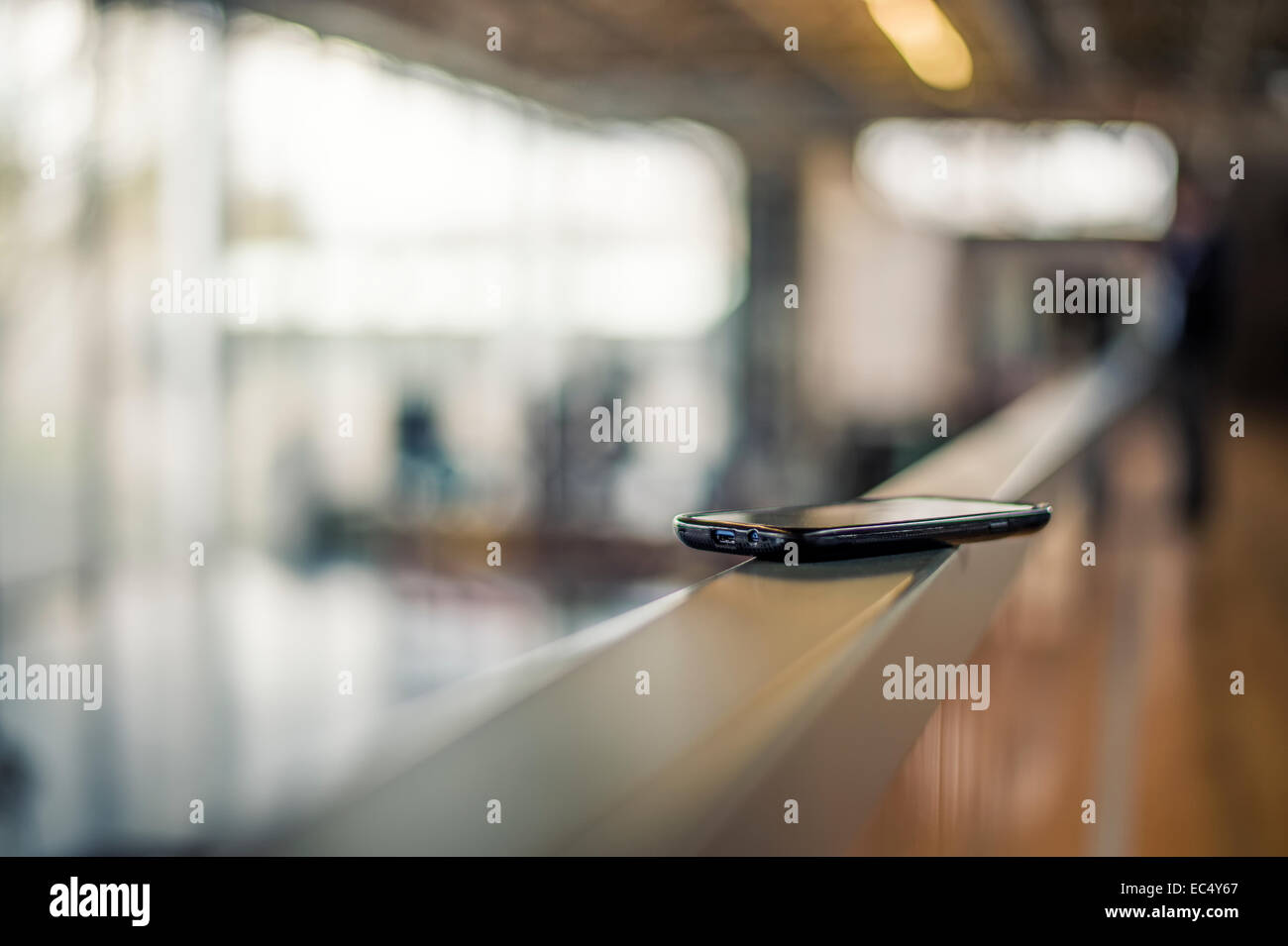 a smart phone is on a railing Stock Photo - Alamy