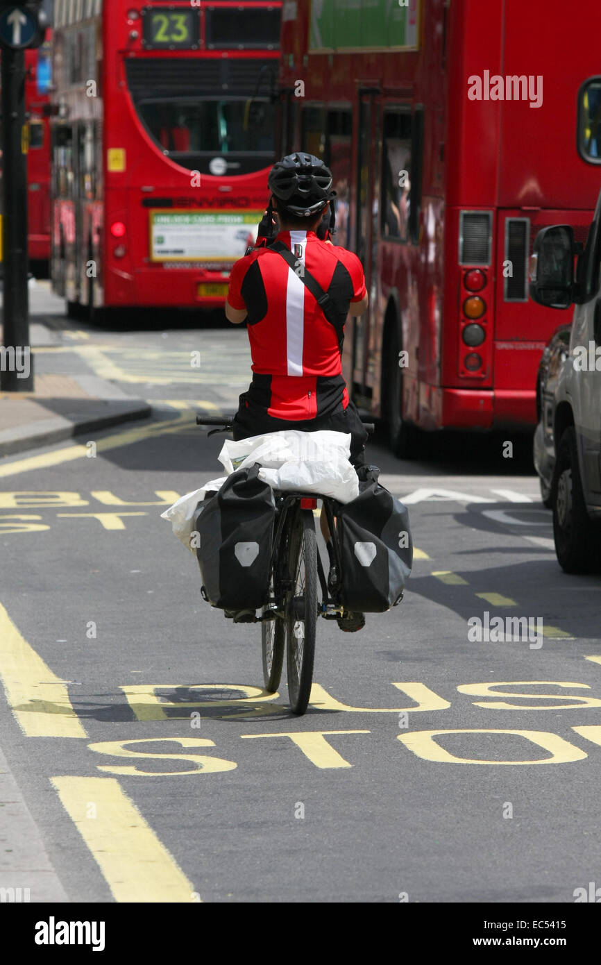 A cyclist traveling in a queue of traffic in Oxford Street, London ...