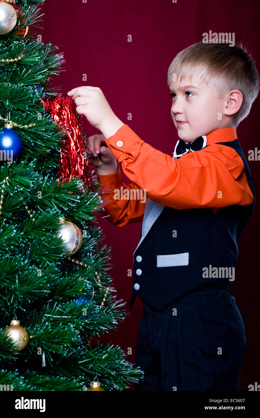 a boy decorating the Christmas tree Stock Photo - Alamy