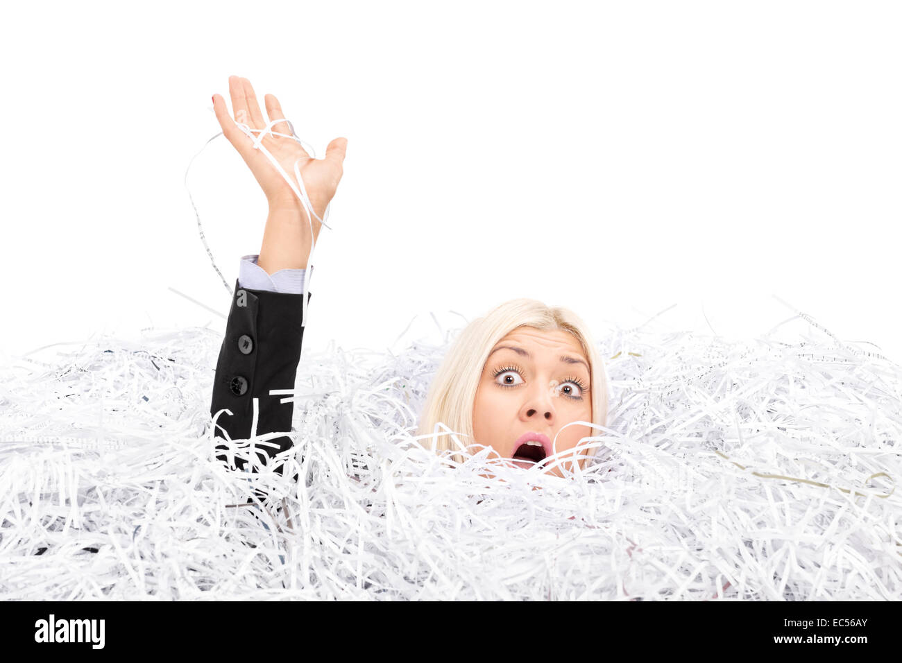 Businesswoman drowning in a pile of shredded paper isolated on white ...