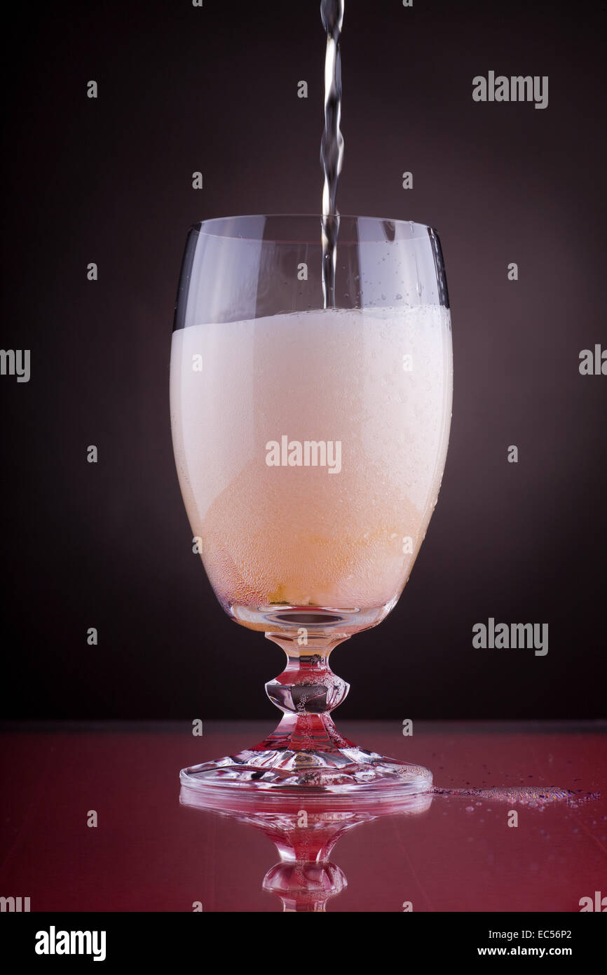a glass beer in front of brown background Stock Photo - Alamy