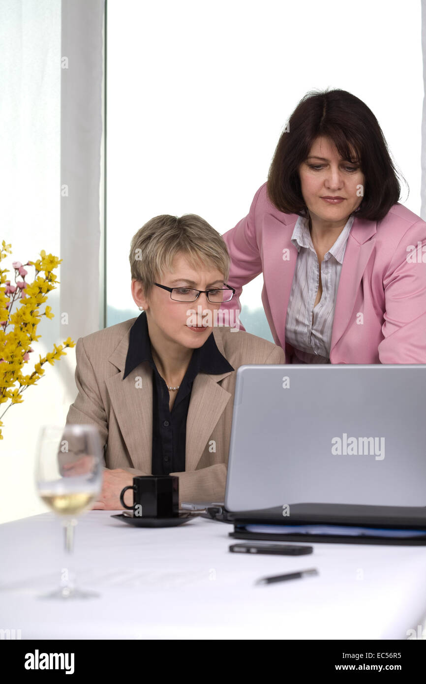 two business women working in the office Stock Photo - Alamy