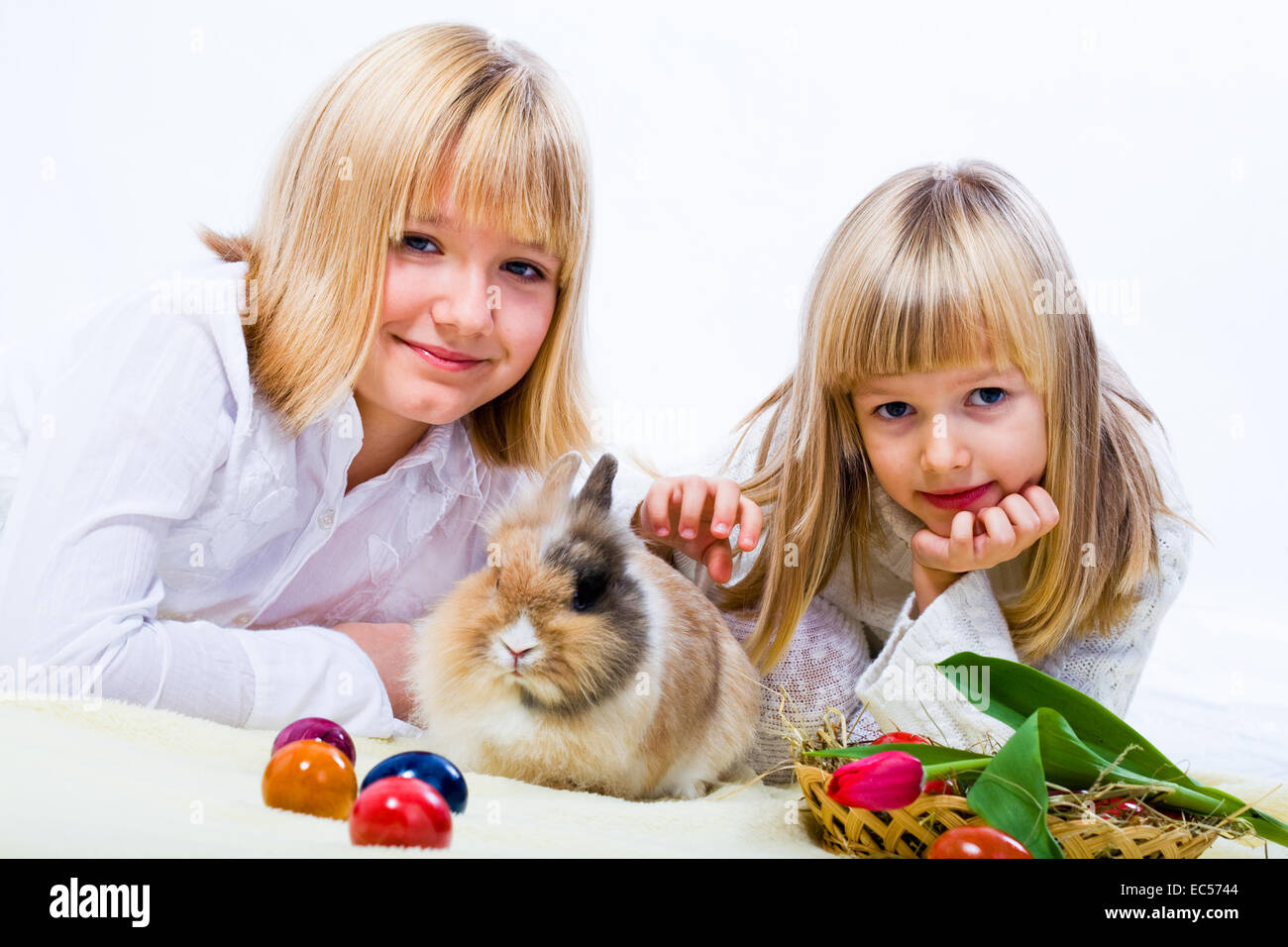 the girls and a eastern rabbit on the white background Stock Photo - Alamy