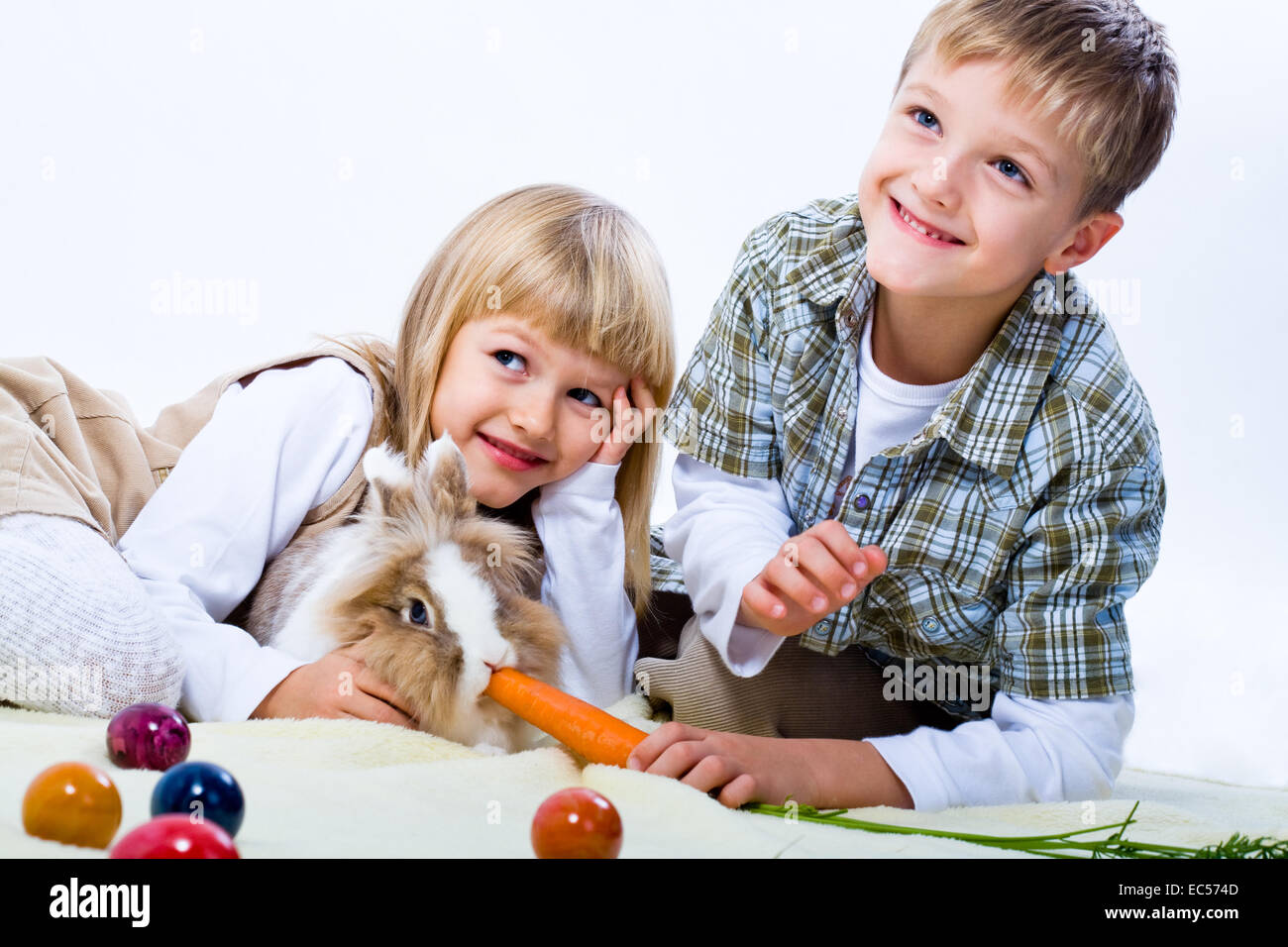 two kids and a eastern rabbit Stock Photo - Alamy