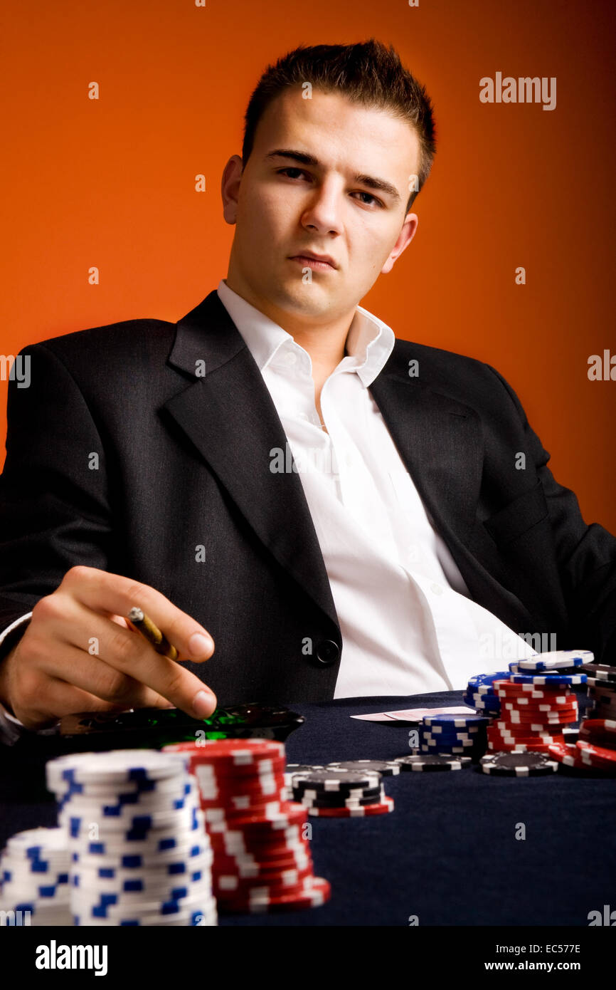 a young man playing poker Stock Photo - Alamy