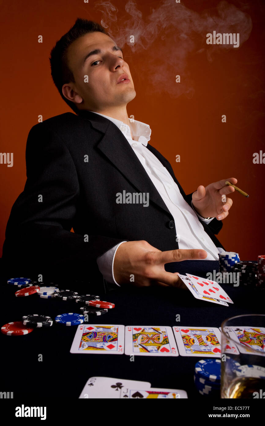 a young man playing poker Stock Photo - Alamy