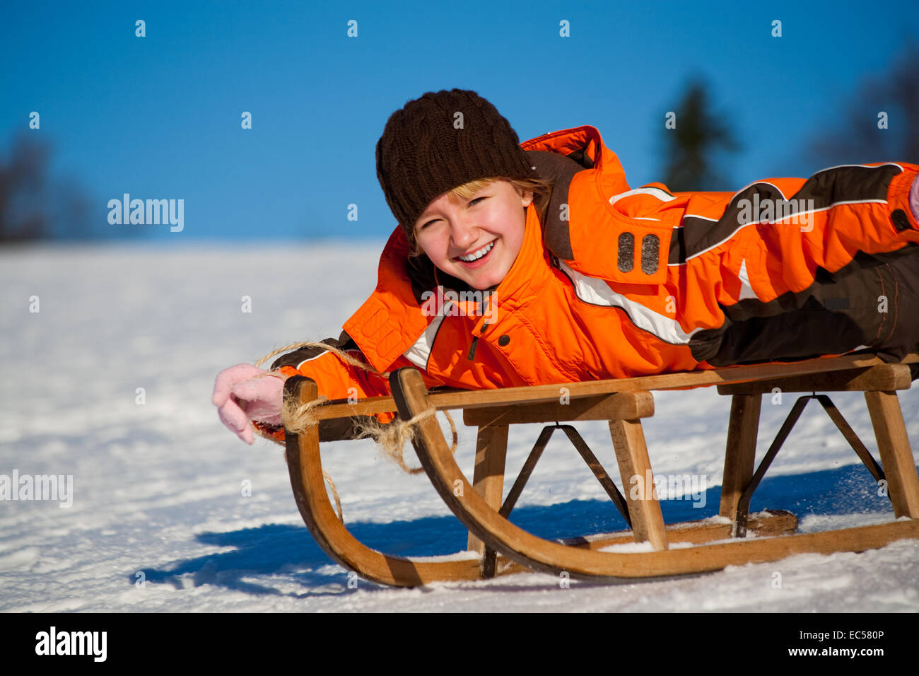 winter activities Girl sledding downhill Stock Photo - Alamy