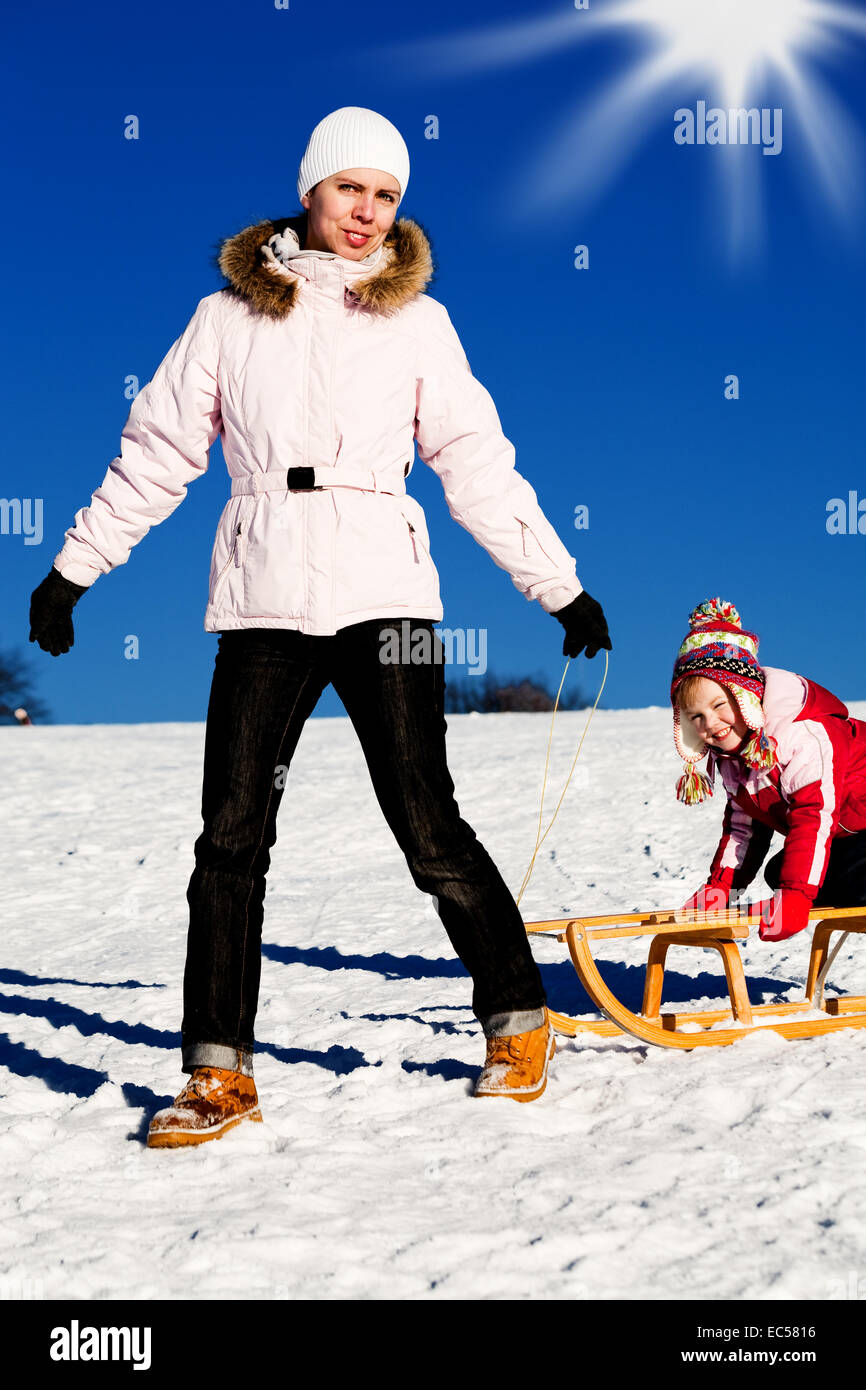 winter activities Mother and daughter sledding downhill Stock Photo - Alamy