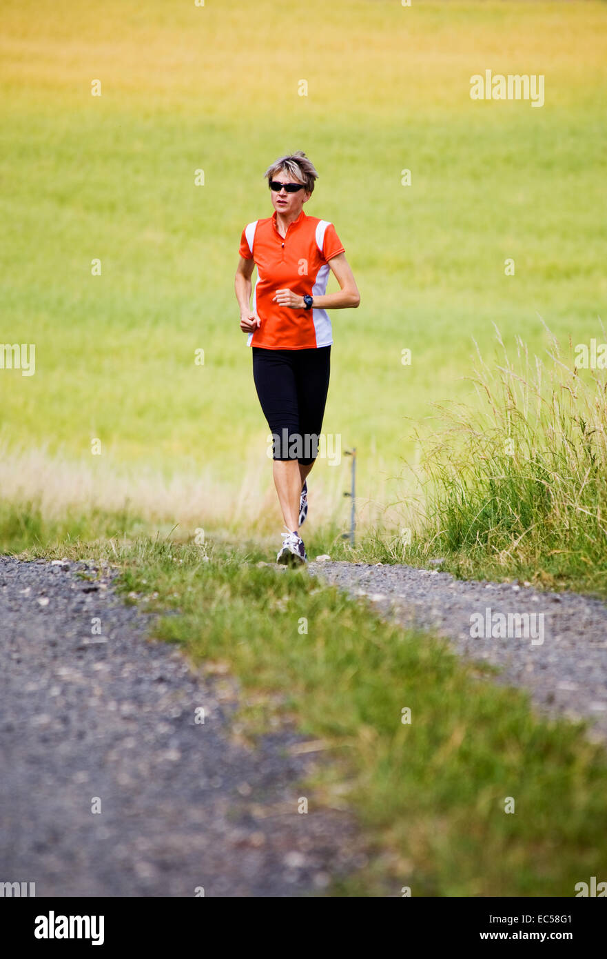 A woman jogging cross country Stock Photo - Alamy