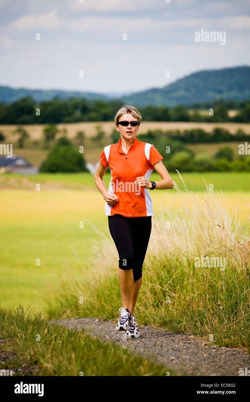 A woman jogging cross country Stock Photo - Alamy