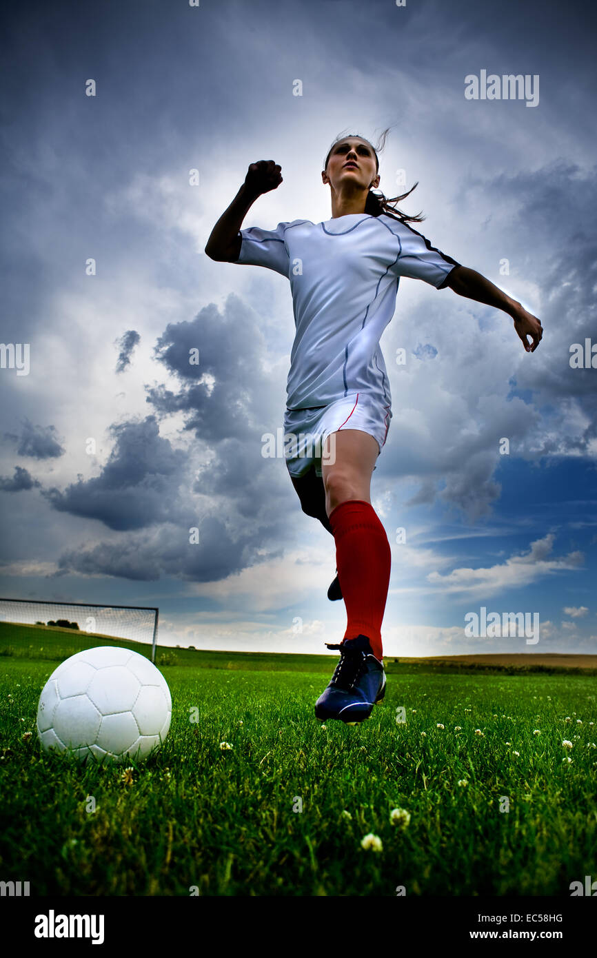 a young female football player on the field Stock Photo - Alamy