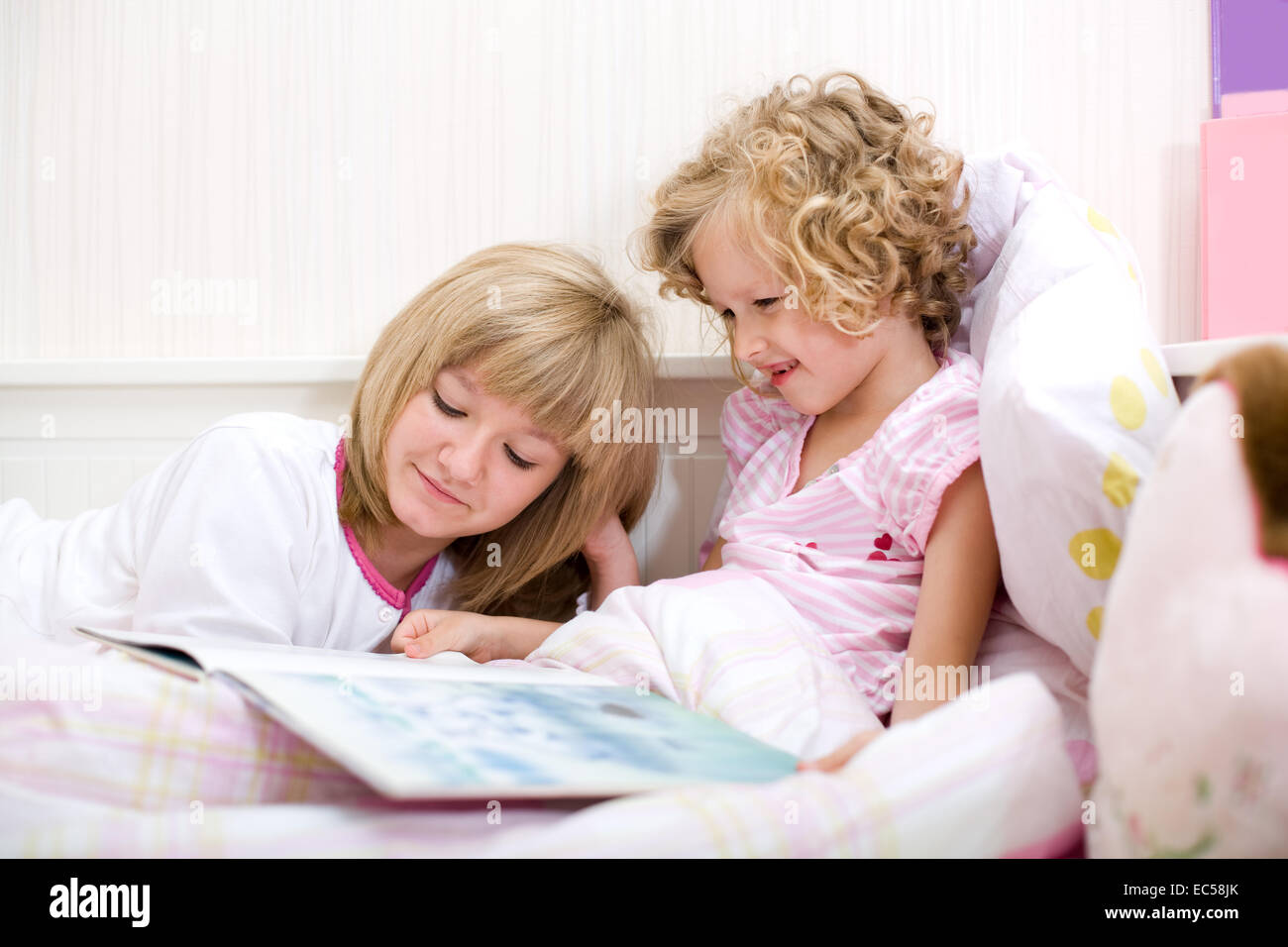 the girls reading in the bedroom Stock Photo - Alamy
