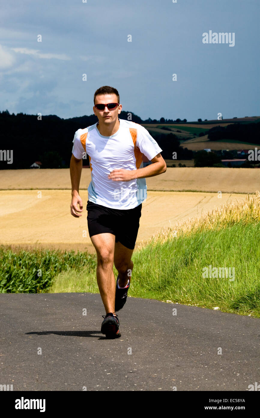 man jogging through the fields Stock Photo - Alamy