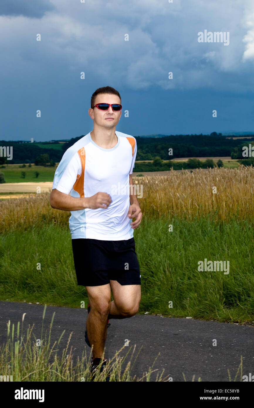 man jogging through the fields Stock Photo - Alamy