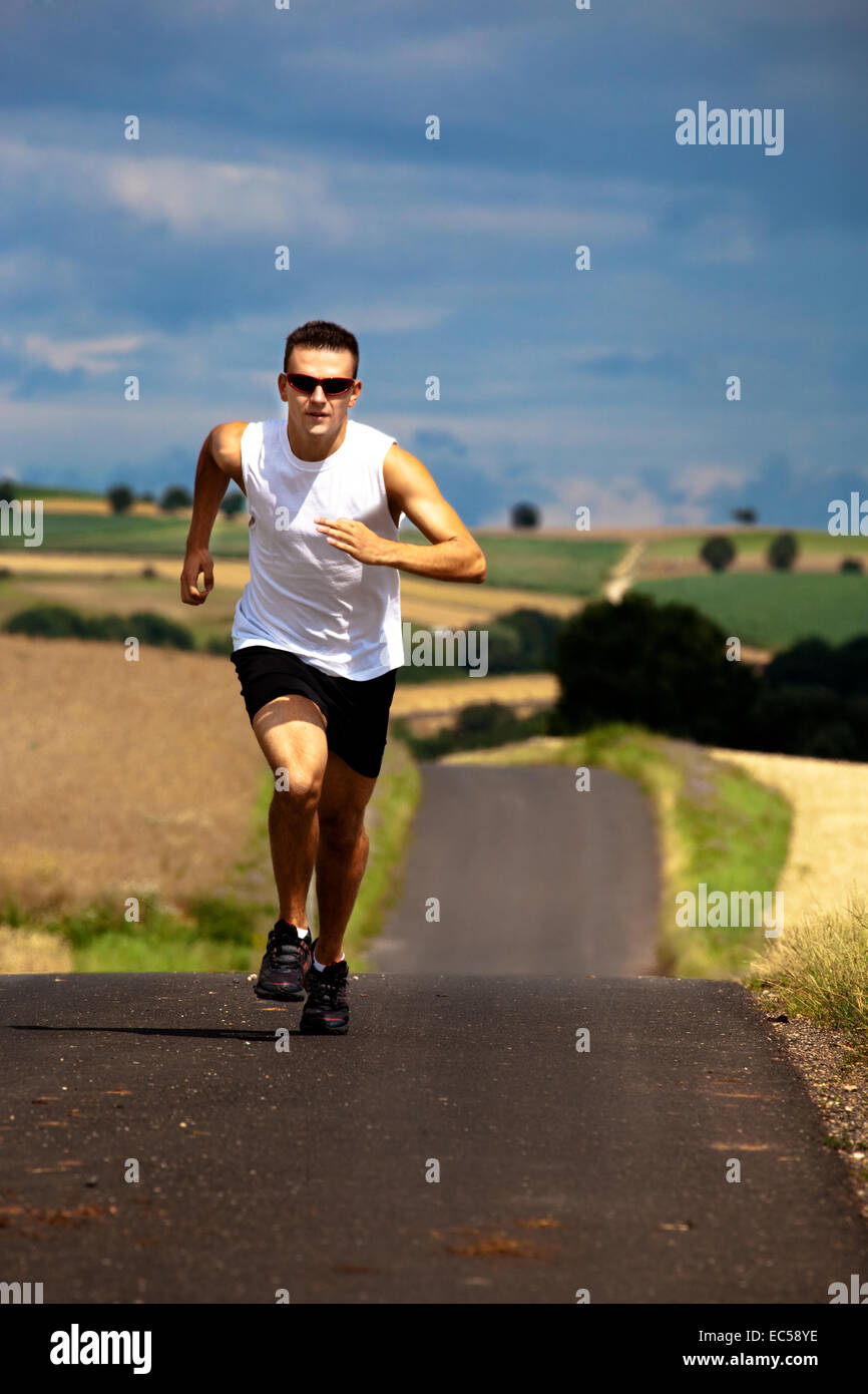 man jogging through the fields Stock Photo - Alamy