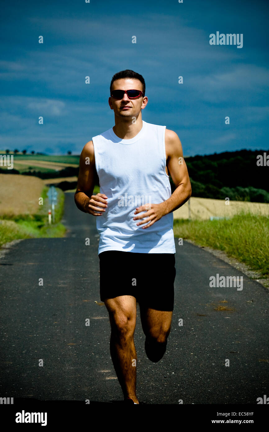 man jogging through the fields Stock Photo - Alamy