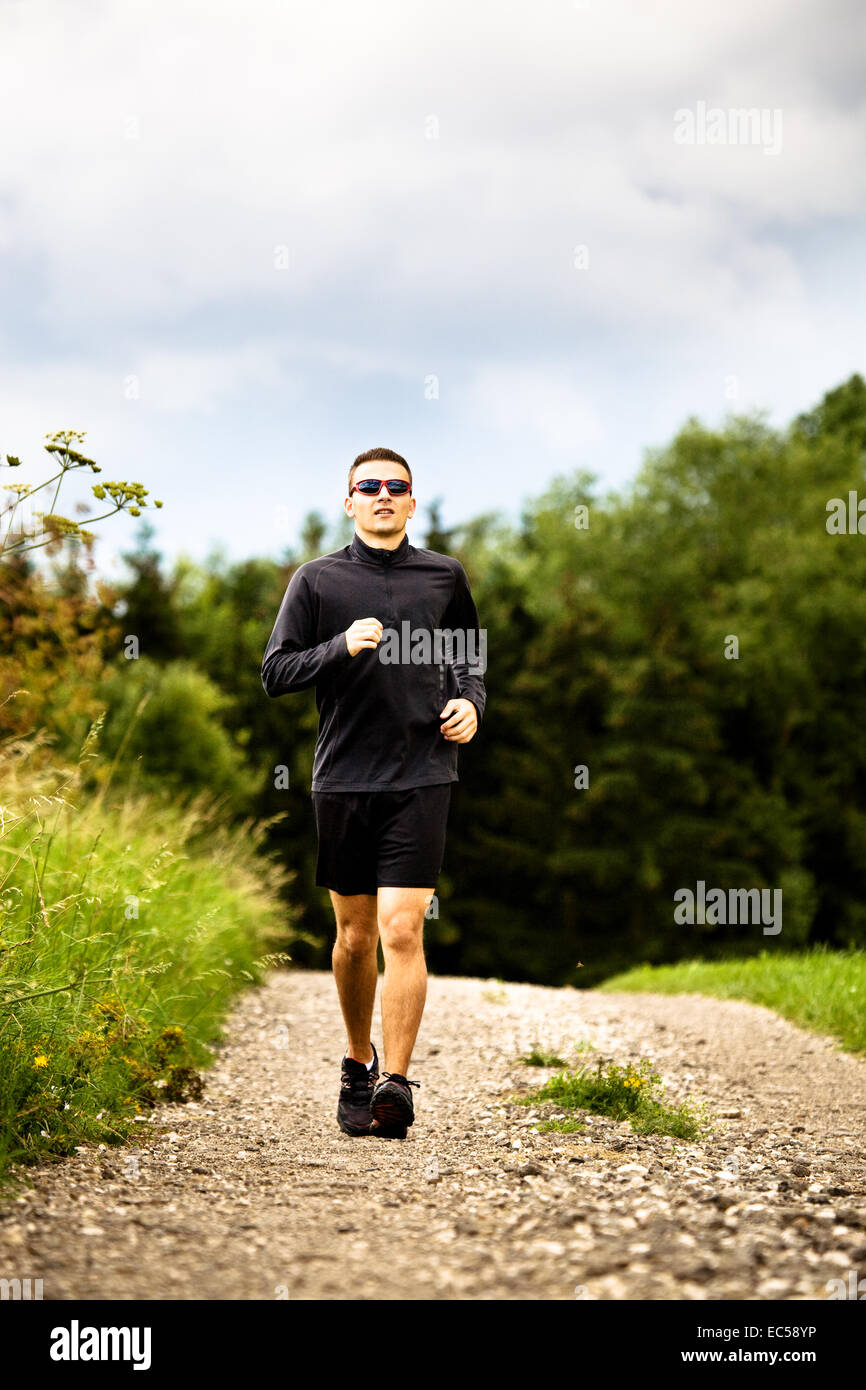 man jogging through the fields Stock Photo - Alamy