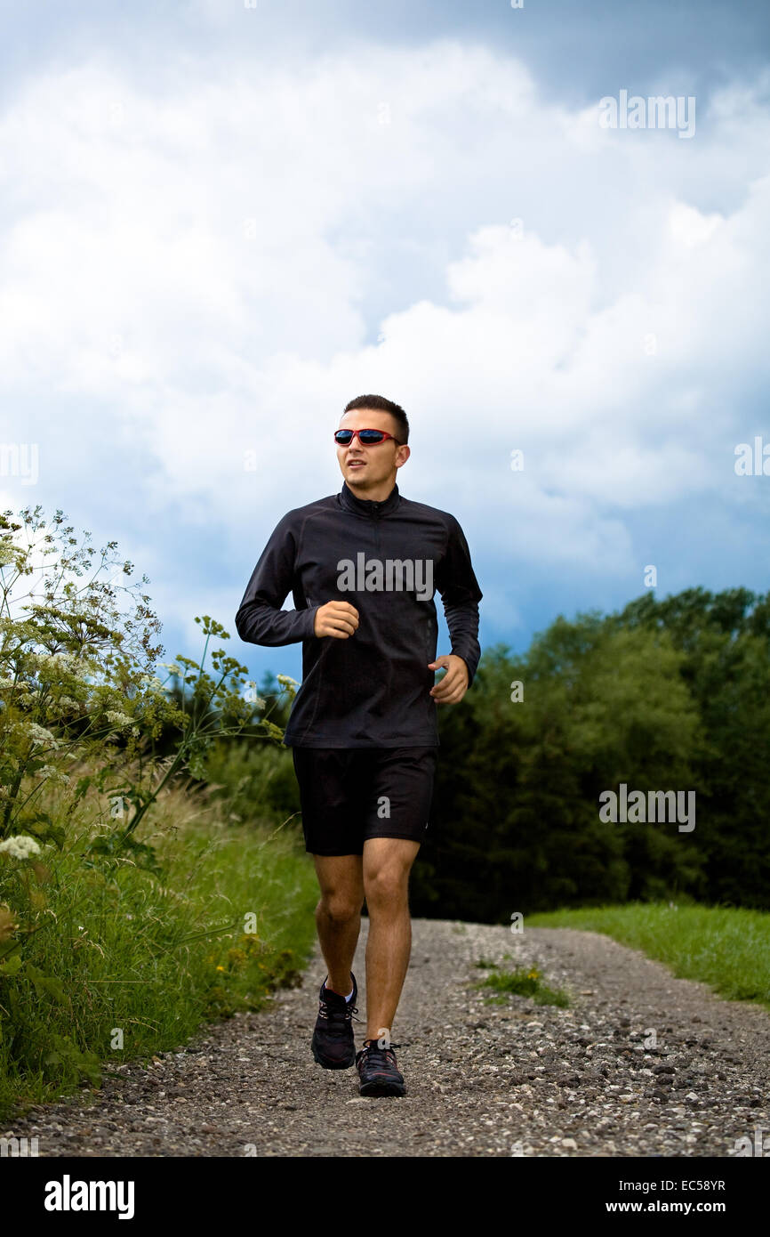 man jogging through the fields Stock Photo - Alamy