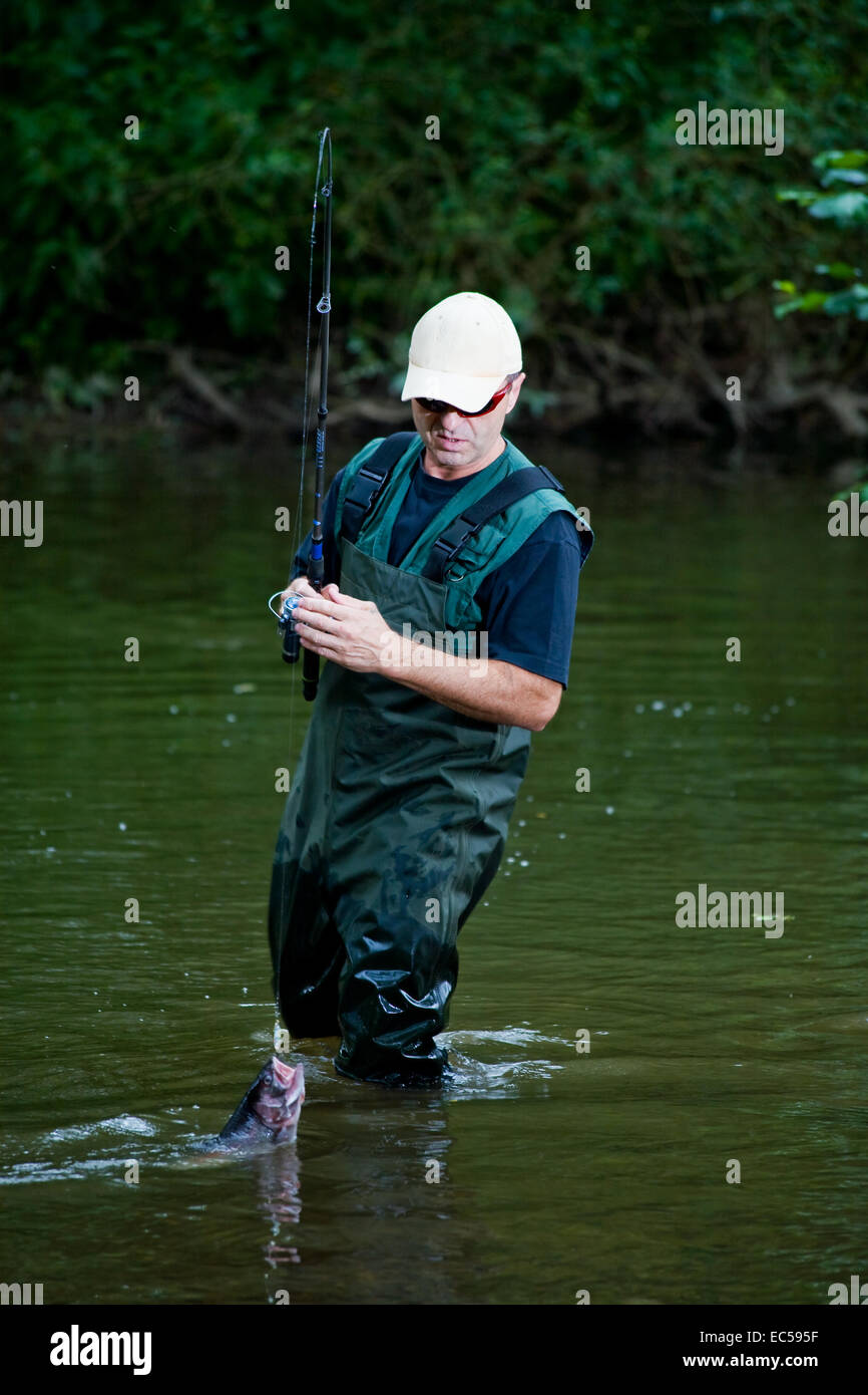 a angler fishing in the river Stock Photo - Alamy