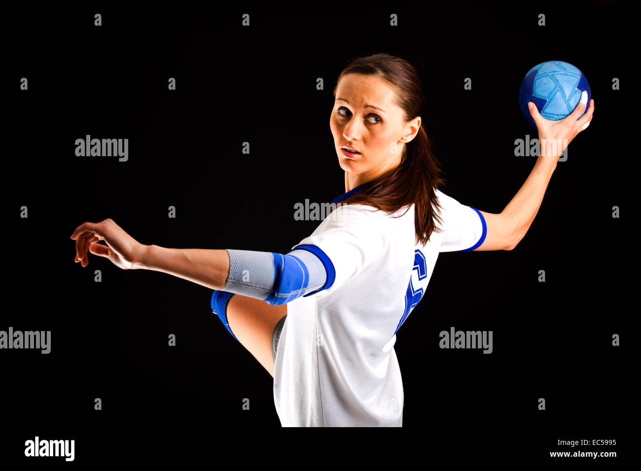 female handball player with a ball Stock Photo - Alamy