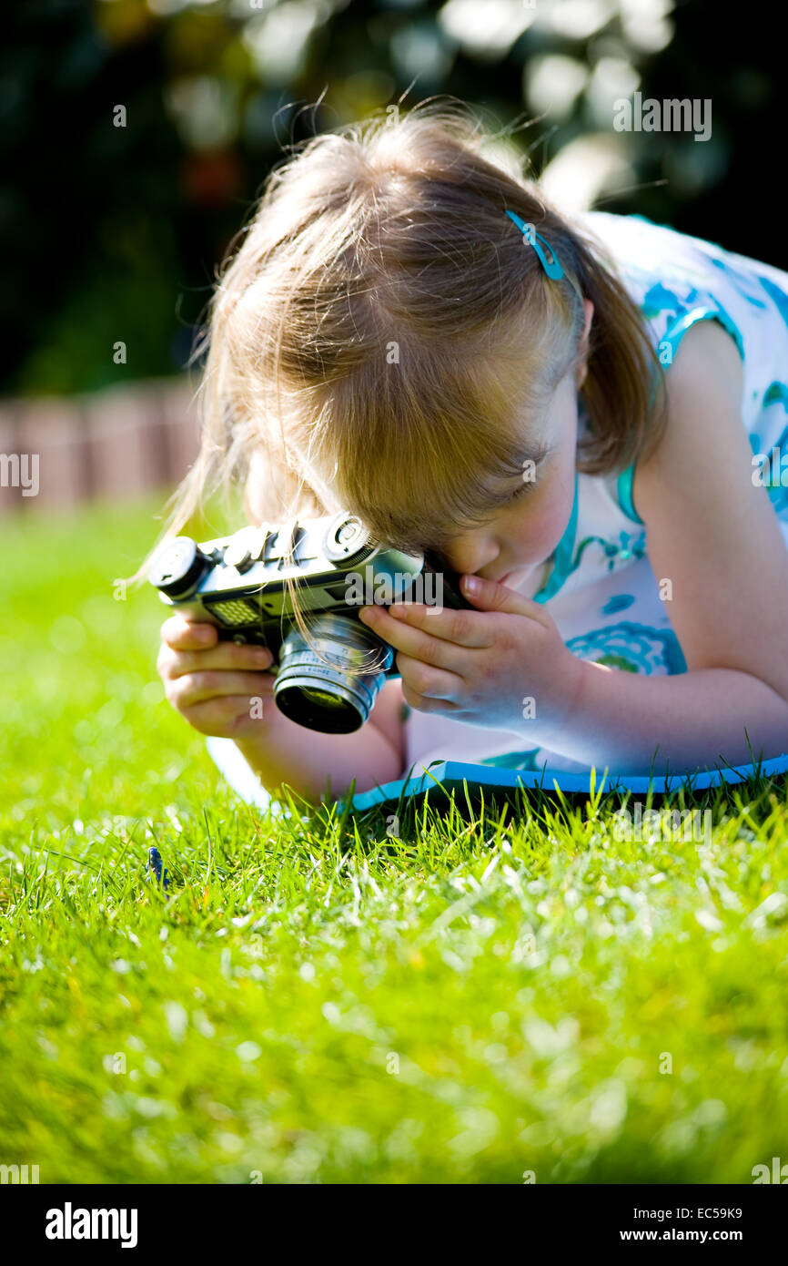 a little girl with a photo camera Stock Photo - Alamy