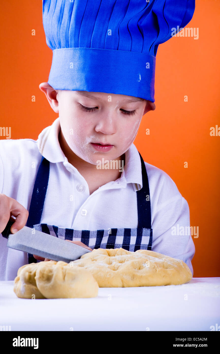 a 6 years old boy baking bread Stock Photo - Alamy