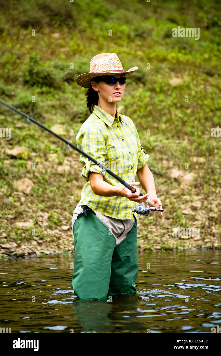 a female angler fishing in the river Stock Photo - Alamy