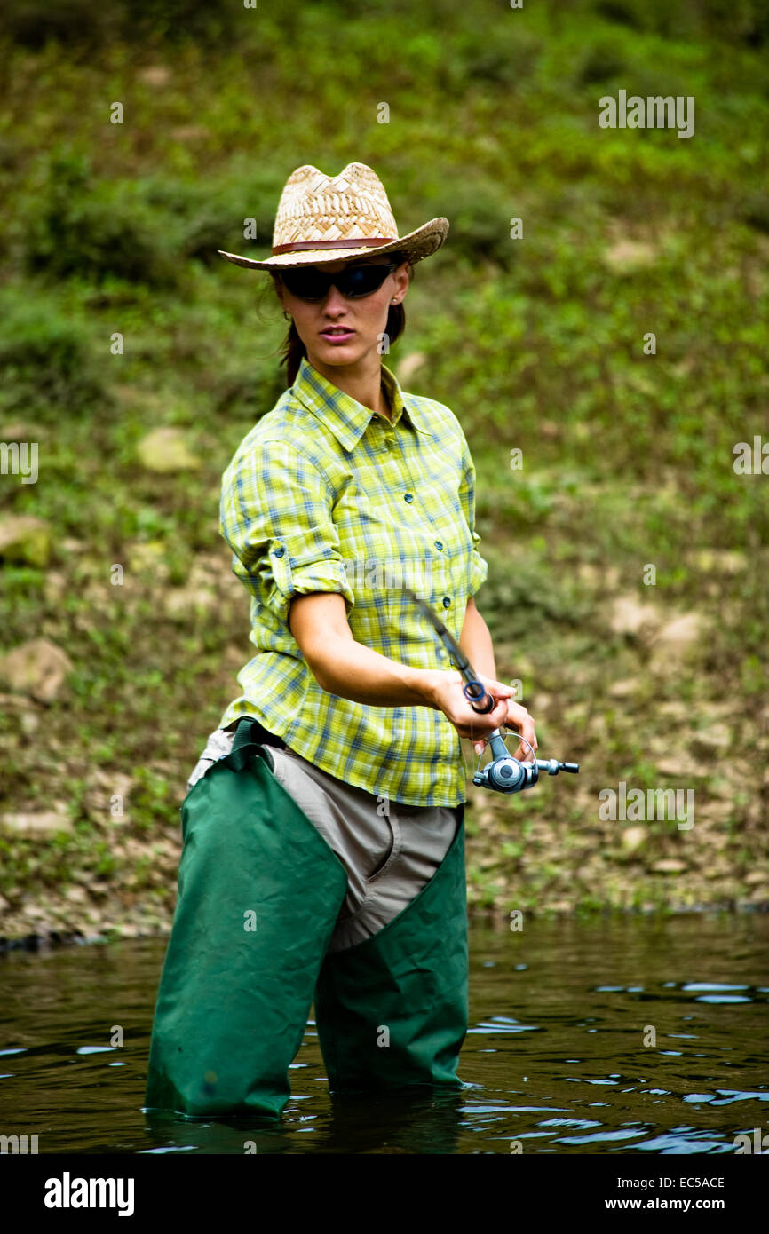 a female angler fishing in the river Stock Photo - Alamy