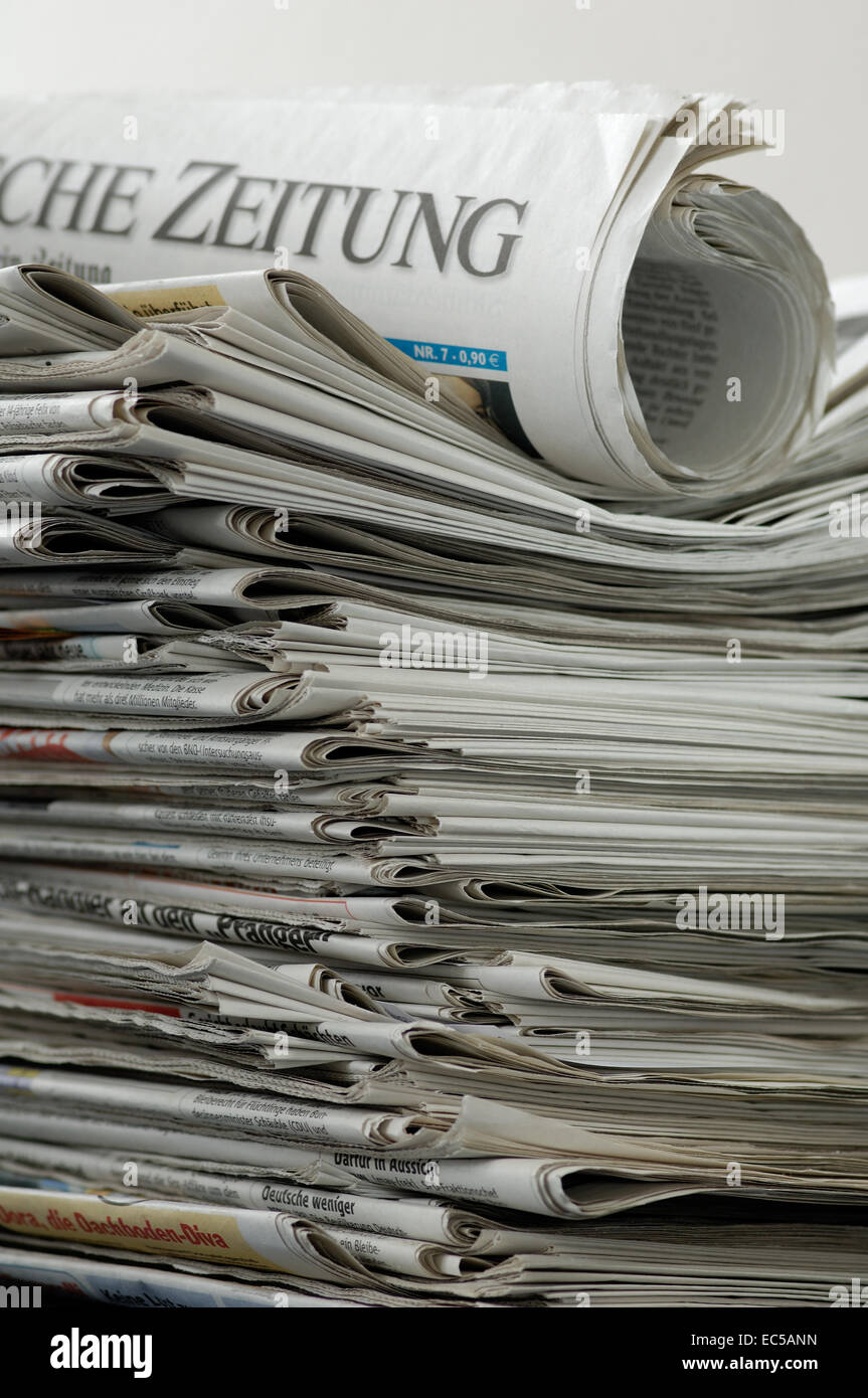 Wrapped newspaper on a pile of newspapers Stock Photo - Alamy