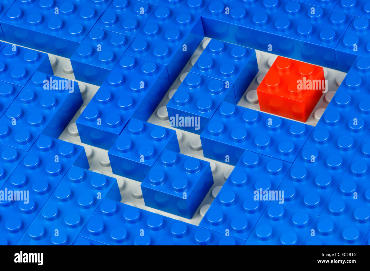 A path trough a field of blue building blocks Stock Photo - Alamy