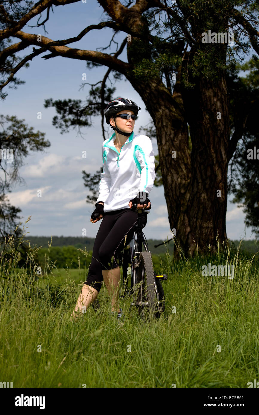 A cycling woman taking a break Stock Photo - Alamy