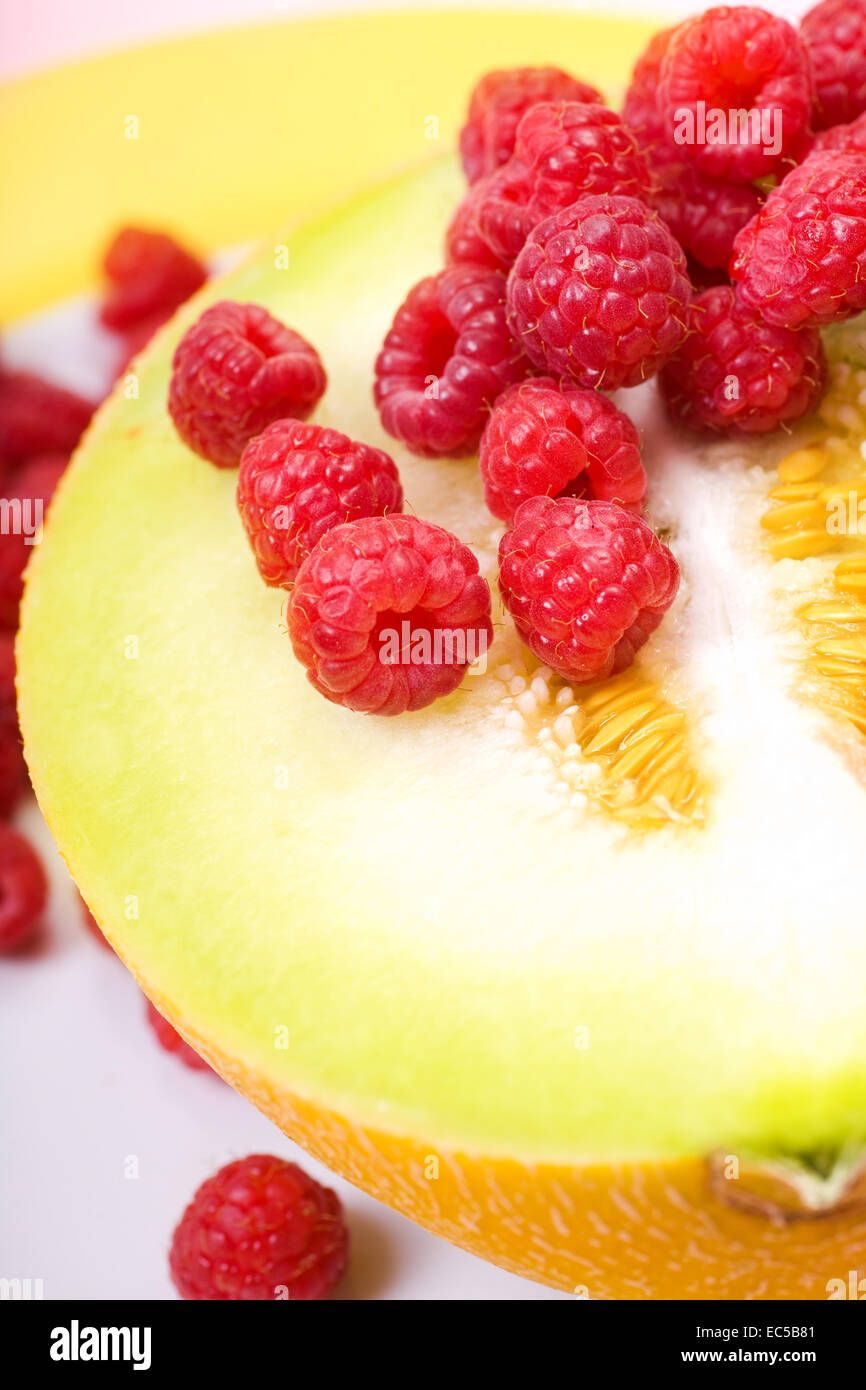 a plate with raspberries and melon Stock Photo - Alamy