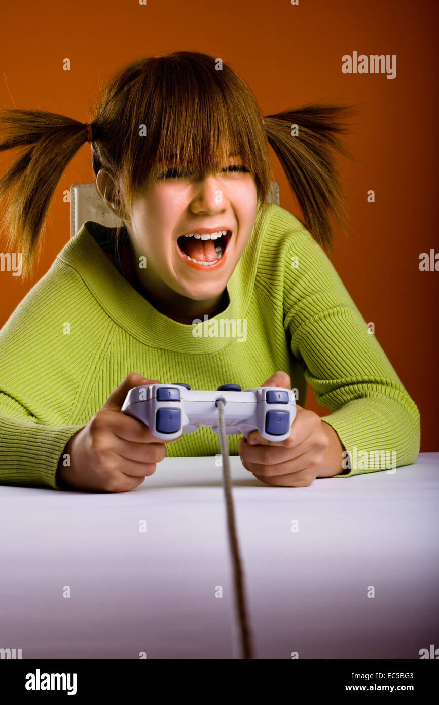 girl with a game controller playing a computer game Stock Photo - Alamy