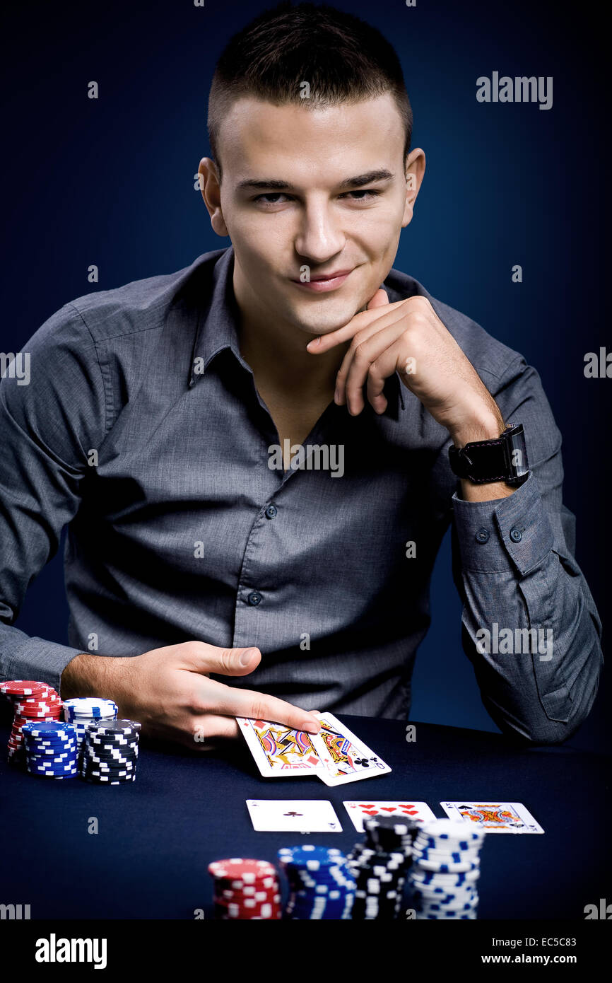 a young man playing poker Stock Photo - Alamy