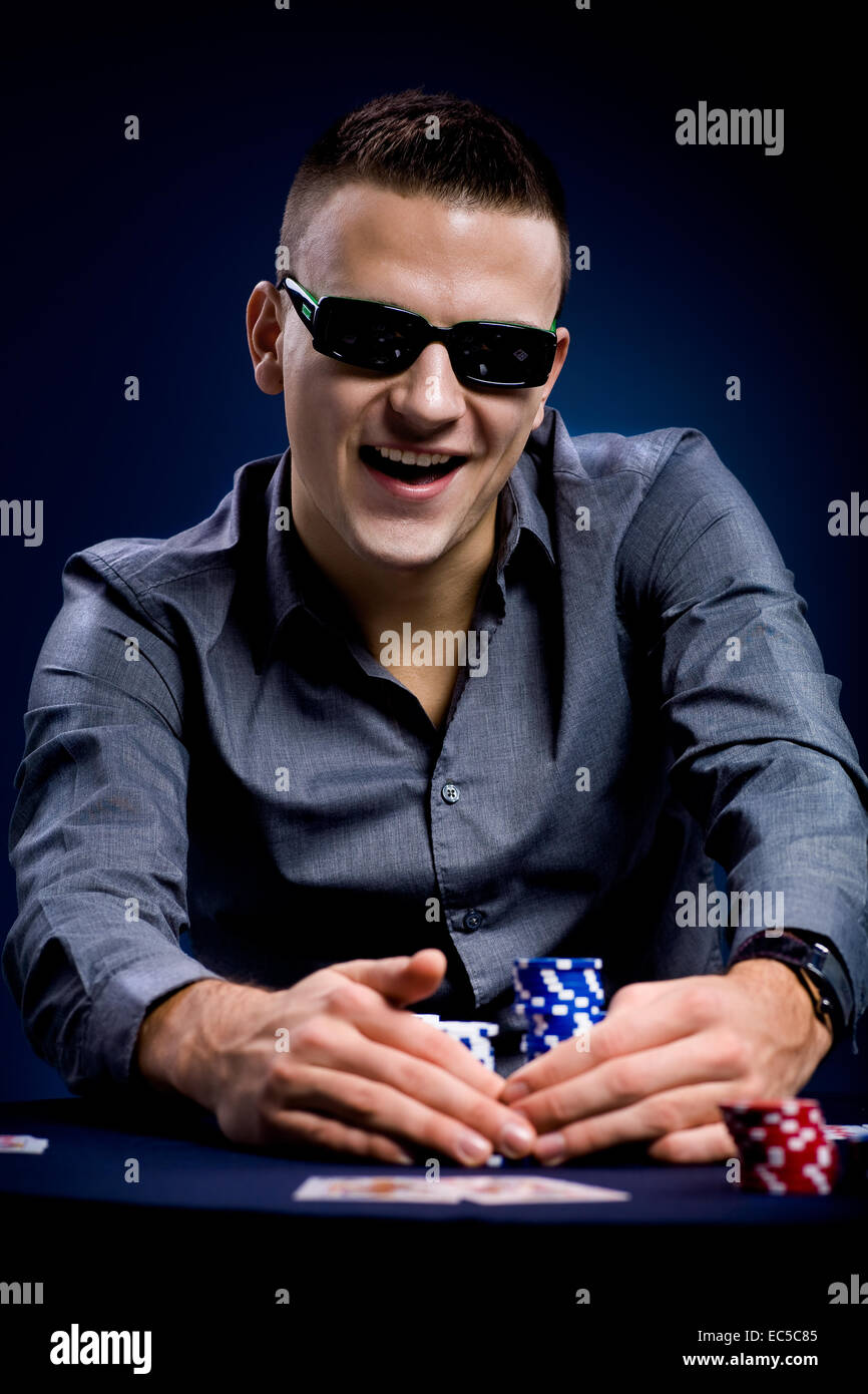 a young man playing poker Stock Photo - Alamy
