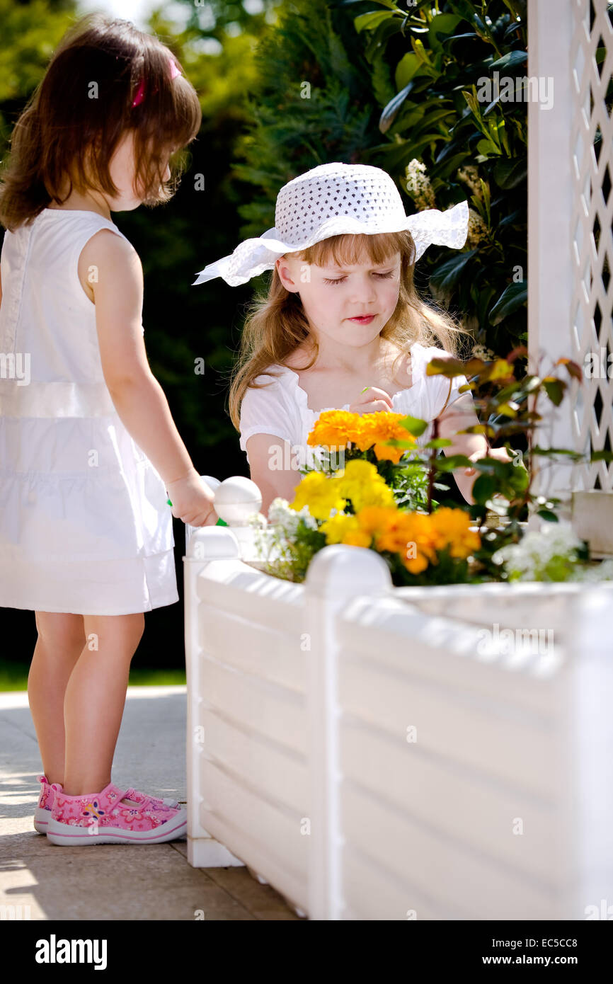 two young girls working in the garden Stock Photo - Alamy