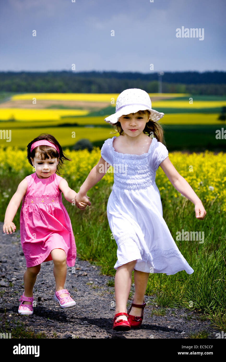 little girls walking and ranking the fields Stock Photo - Alamy