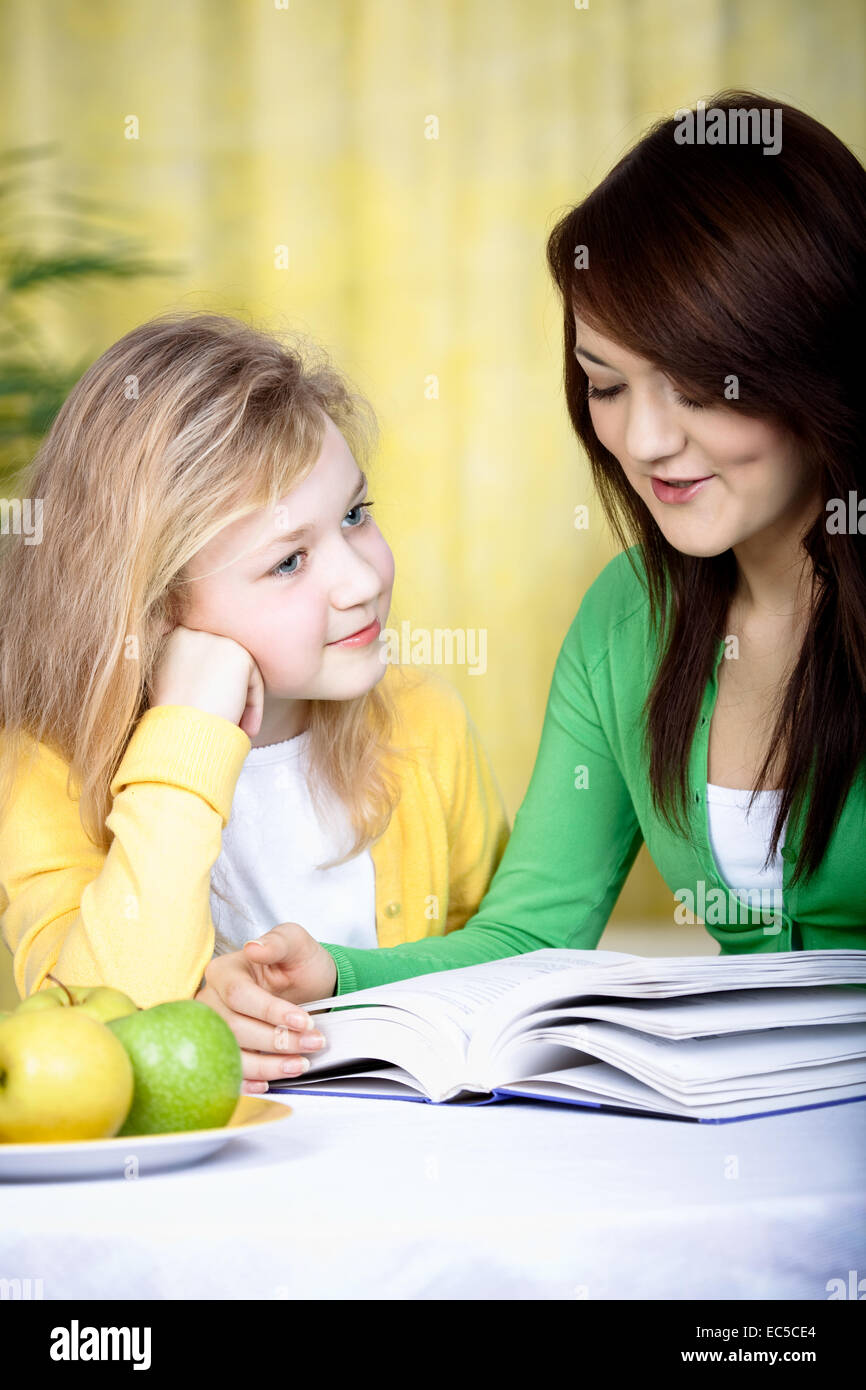 girls reading a book at home Stock Photo - Alamy