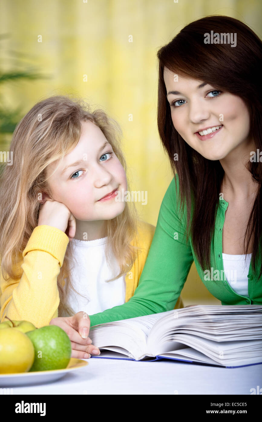 girls reading a book at home Stock Photo - Alamy